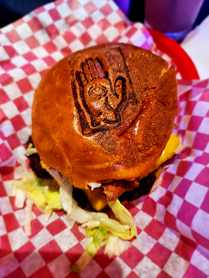 This isn't just a burger&mdash;it's a branded experience. The hand stamp on the bun says "you're one of us now."