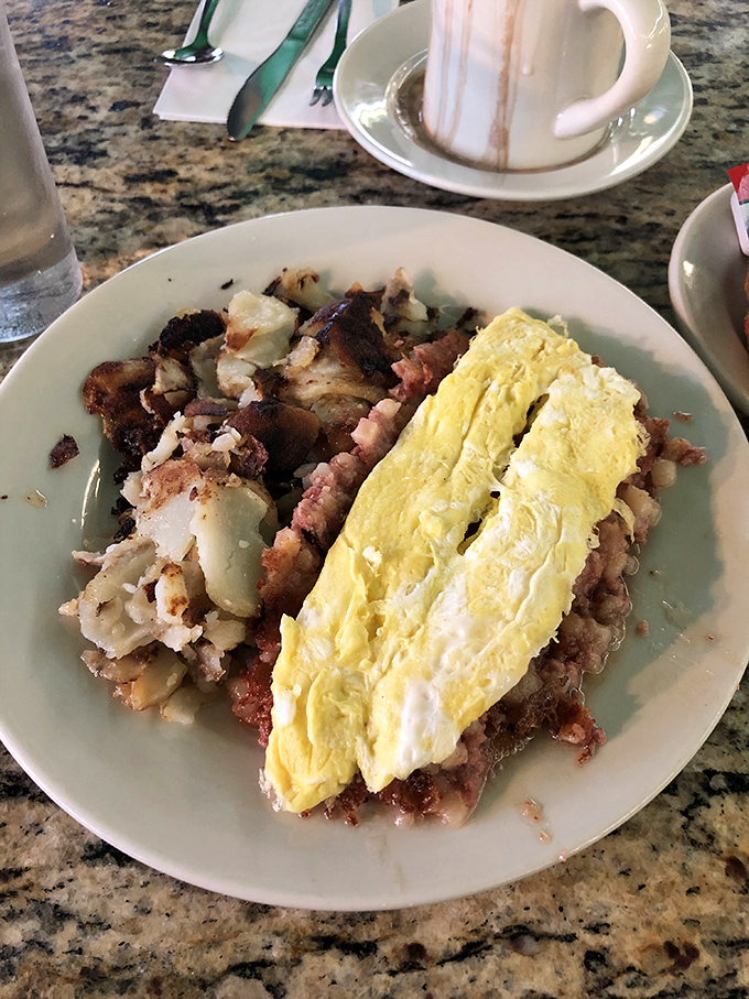 Breakfast nirvana achieved! The marriage of crispy-edged corned beef hash and folded eggs creates the comfort food equivalent of a warm hug.