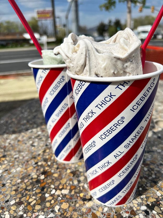 These aren't just shakes&mdash;they're architectural marvels of dairy engineering, standing tall and proud in their red, white, and blue striped uniforms.
