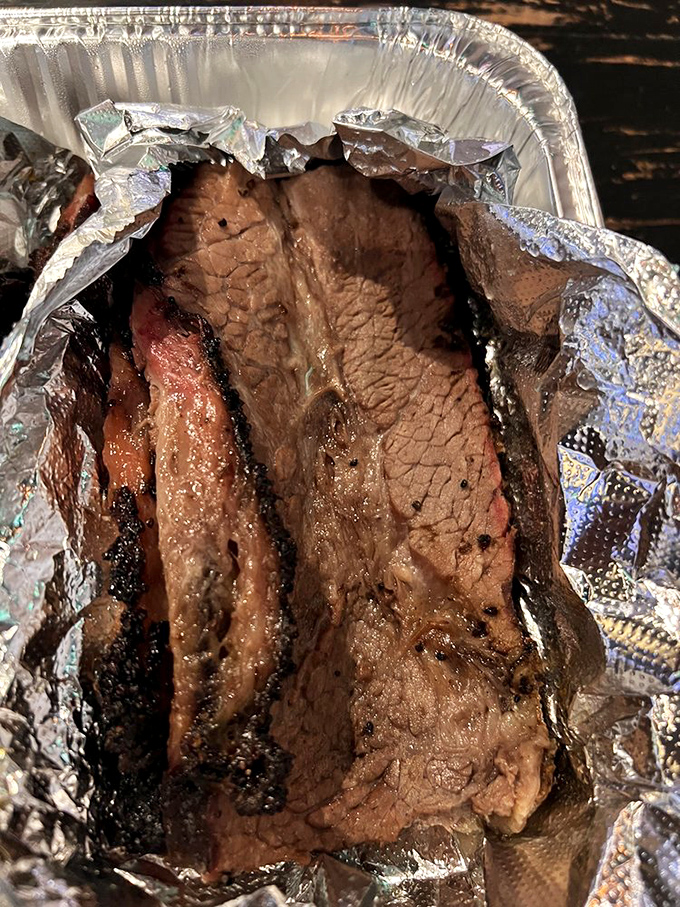 This brisket has the kind of smoke ring that deserves its own jewelry commercial. "Every kiss begins with... perfectly rendered fat."