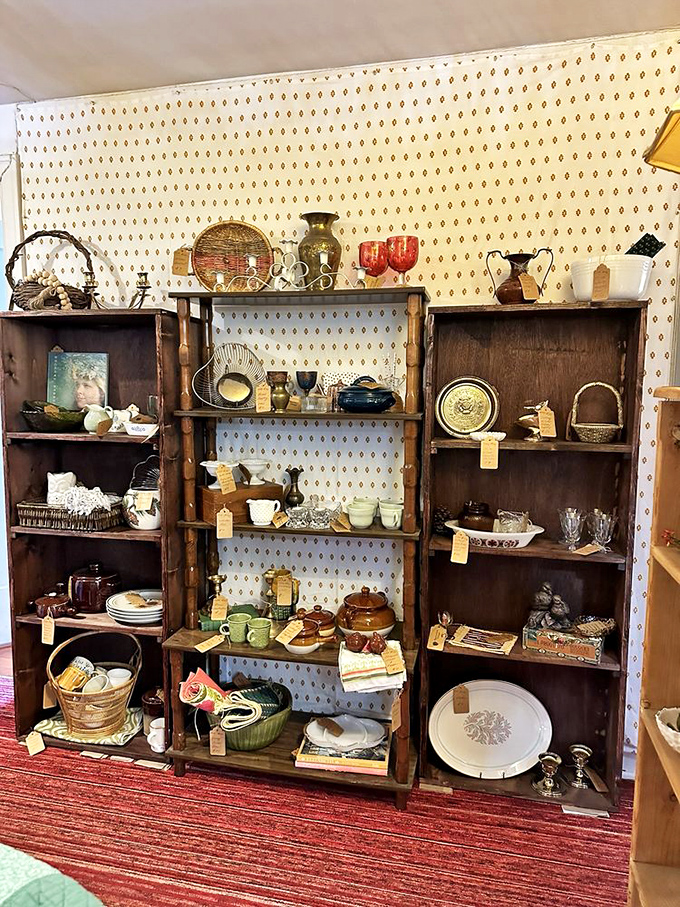 Kitchen history displayed with loving care. These wooden shelves showcase the evolution of American dining, from Depression glass to mid-century serving pieces.