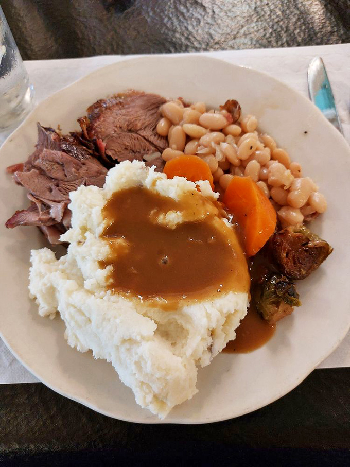 A plate that answers the eternal question: "What if comfort food could give you a hug?" Mashed potatoes, gravy, and beans create the holy trinity of satisfaction.