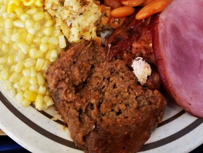 A plate that answers the eternal question: "What would heaven look like if it were served on earthenware?" Meatloaf, ham, stuffing, and corn—the Mount Rushmore of comfort.