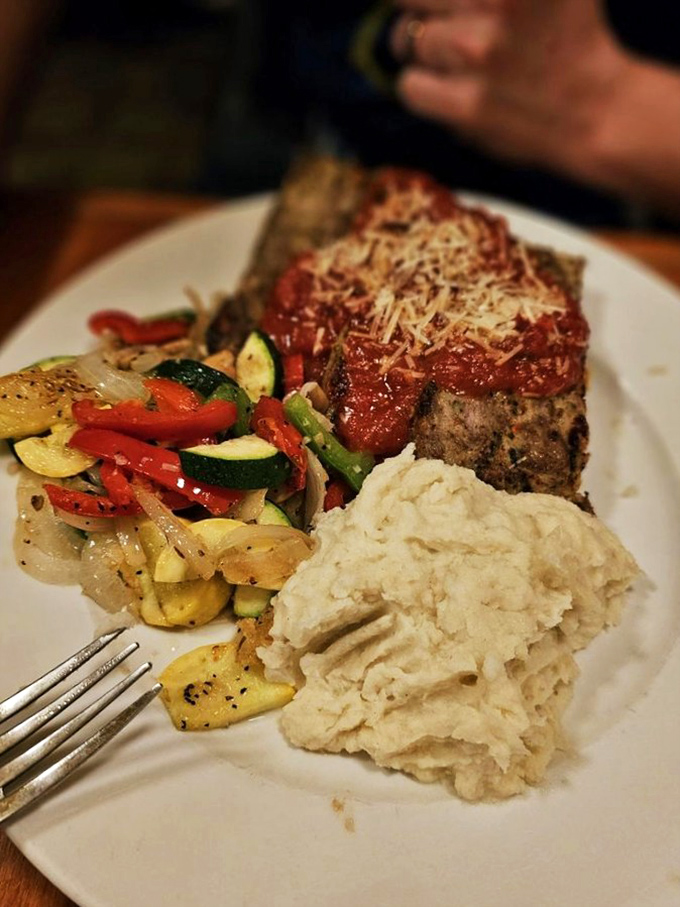 This isn't just meatloaf&mdash;it's a masterclass in comfort, topped with tangy tomato sauce and served with vegetables that didn't come from a freezer.