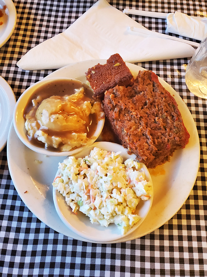 The star attraction arrives: thick-sliced meatloaf paired with creamy coleslaw and mashed potatoes that put spa treatments to shame.