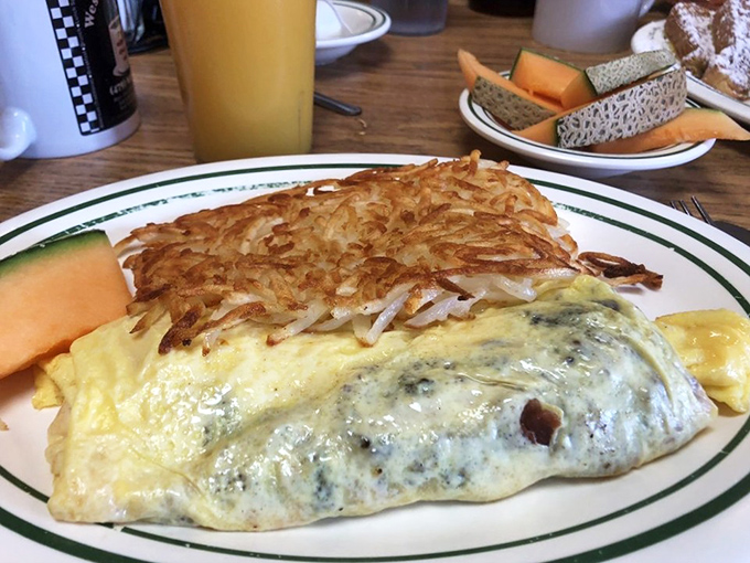 This omelet didn't just happen—it was engineered for maximum happiness. The hash browns look like they're auditioning for a breakfast hall of fame.