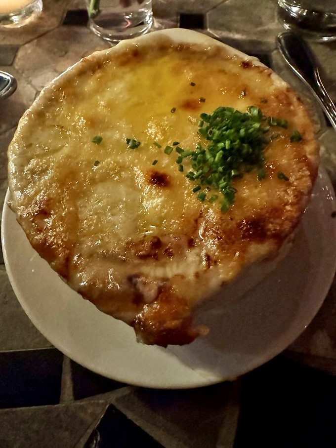 The French onion soup's cheese pull deserves its own Instagram account&mdash;a magnificent canopy protecting the rich, dark broth below.