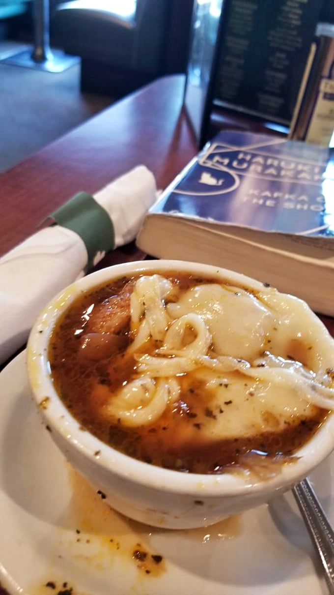 The French onion soup mid-excavation reveals its secrets: sweet caramelized onions swimming in broth that's been simmering since Tuesday.
