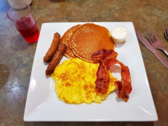 The breakfast trinity in its purest form&mdash;golden pancakes, sunshine-yellow eggs, and bacon that's achieved that perfect balance between crisp and chewy. Morning poetry on a plate.