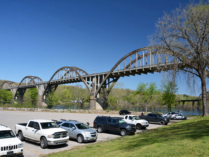 "Park here for instant adventure," says the sign that doesn't exist but should. Fishermen's vehicles await while their owners chase rainbow trout below.
