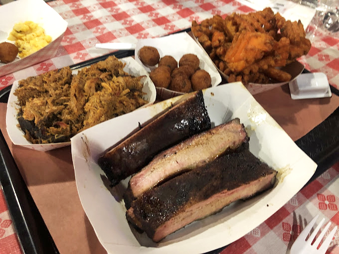 This tray is what barbecue dreams are made of. The pulled pork has that perfect bark-to-meat ratio, while those hush puppies are practically begging to be dunked.