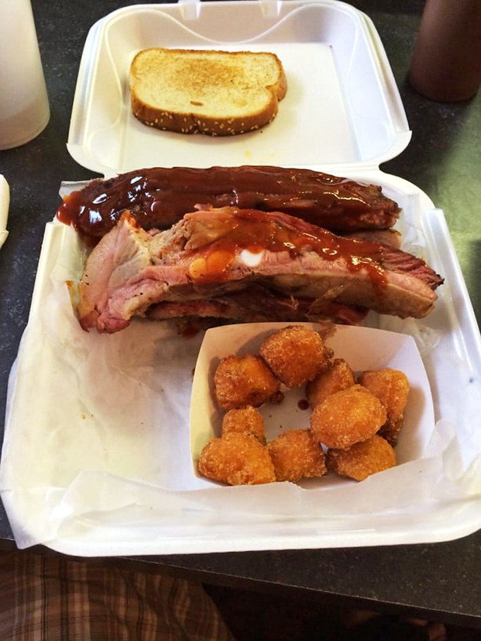 These ribs don't need a fancy introduction&mdash;just look at that bark, that glaze, those perfectly fried tots. Poetry on a styrofoam plate.