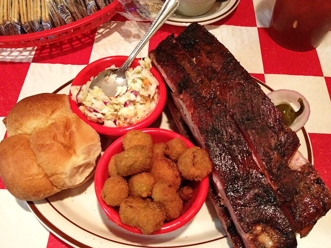 The barbecue trinity: perfectly smoked ribs, creamy coleslaw, and golden hush puppies. This plate doesn't just satisfy hunger&mdash;it creates memories.