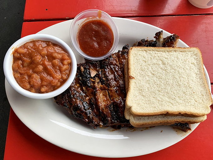 The holy trinity of Southern comfort: ribs, white bread, and baked beans. Napkins required, restraint optional.