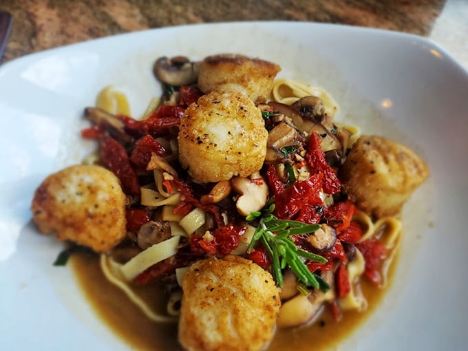 Who knew Amish Country could deliver seafood this sophisticated? Seared scallops dance with pasta and sun-dried tomatoes in a dish that whispers "I'm worth the drive."