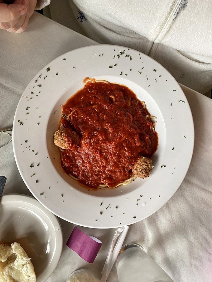 These meatballs aren't just placed on the spaghetti&mdash;they're enthroned upon it, like meaty royalty overseeing their tomatoey kingdom.