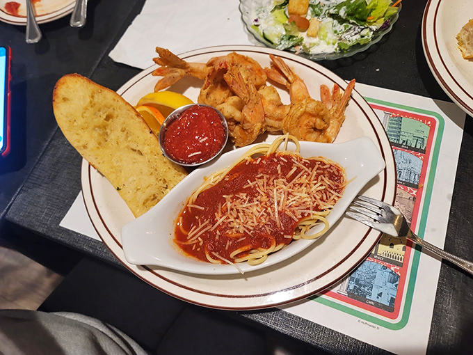 A perfect trifecta: golden garlic bread for dipping, plump shrimp for savoring, and spaghetti with marinara for twirling. Happiness on a plate, Italian-style.