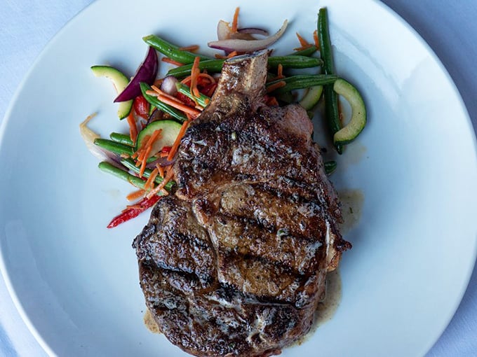 A perfectly seared steak with colorful vegetables&mdash;proof that sometimes the simplest pleasures require the most sophisticated execution.