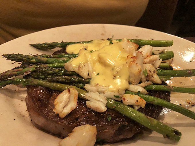 Surf meets turf in perfect harmony &ndash; tender steak crowned with asparagus spears and succulent shrimp, proving that sometimes more really is more.