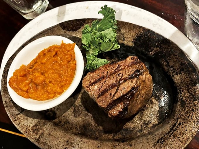 This filet mignon isn't just cooked, it's been coaxed to perfection, sitting proudly alongside mashed sweet potatoes like steak royalty.