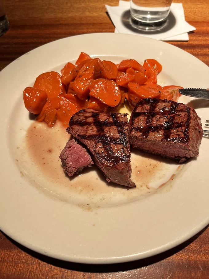 Those grill marks aren't just for show&mdash;they're flavor tattoos telling stories of fire and patience. Sweet glazed carrots play supporting role.