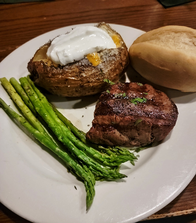 A perfectly cooked steak, a loaded baked potato, and asparagus&mdash;the holy trinity of steakhouse dining that never goes out of style.