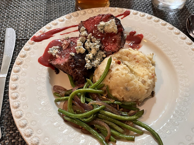 This steak wears its gorgonzola like a royal crown, with a perfectly pink center that whispers, "They know exactly what they're doing here."