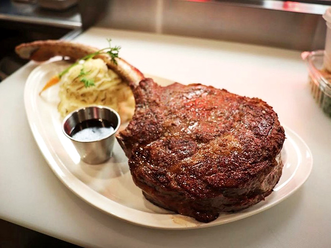 The tomahawk isn't just a cut of meat; it's performance art with a bone handle. Fred Flintstone would weep tears of joy at this primal, perfectly-seared masterpiece.