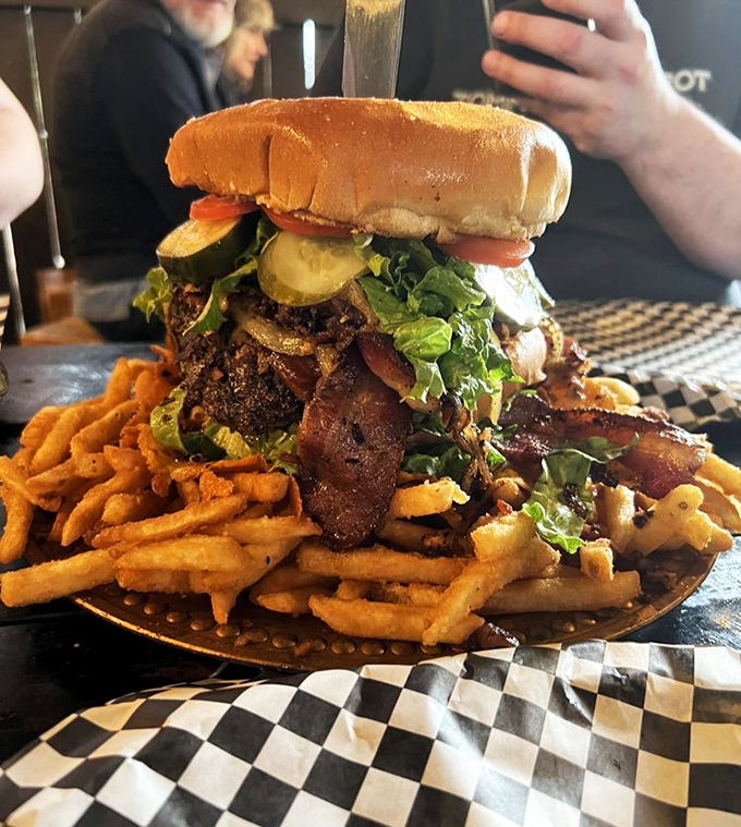 When your burger needs its own zip code. The fries aren't a side dish&mdash;they're the foundation holding up this towering masterpiece of meat.