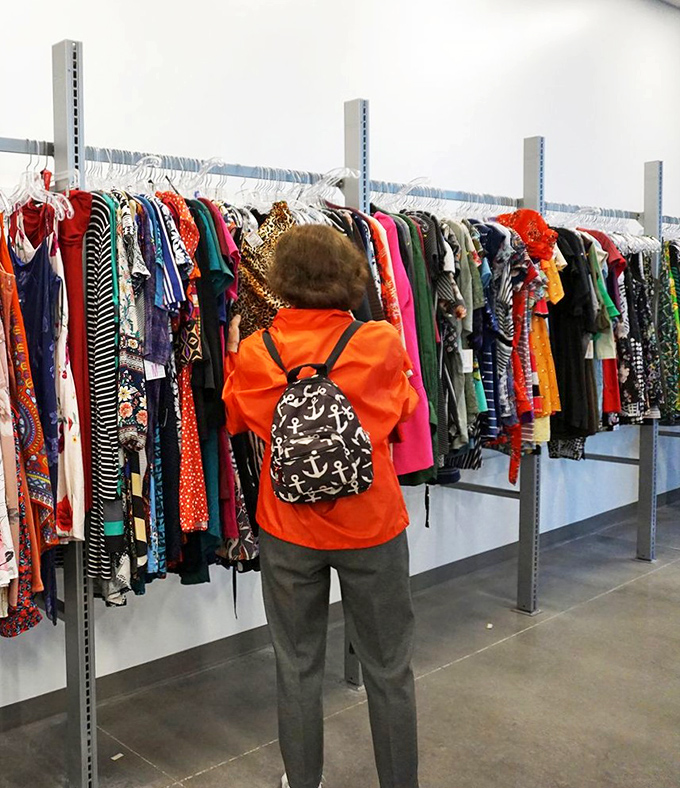 Treasure hunters navigate colorful clothing racks with the focus of archaeologists, knowing the next great discovery could be just a hanger away.