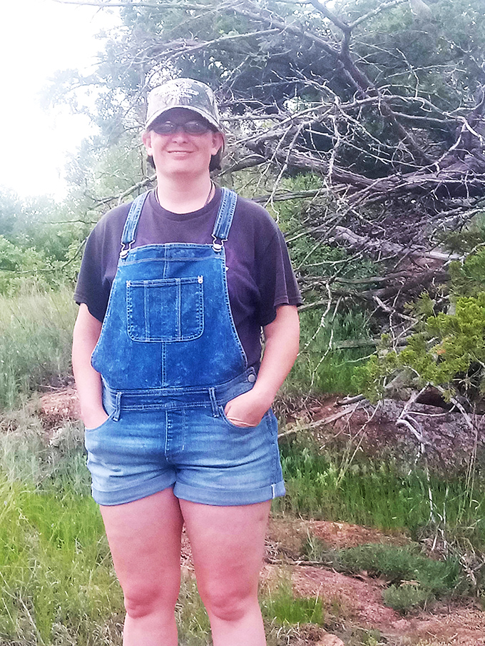 A visitor enjoying the natural surroundings of the wildlife refuge, where hiking trails offer intimate encounters with Oklahoma's wild spaces.