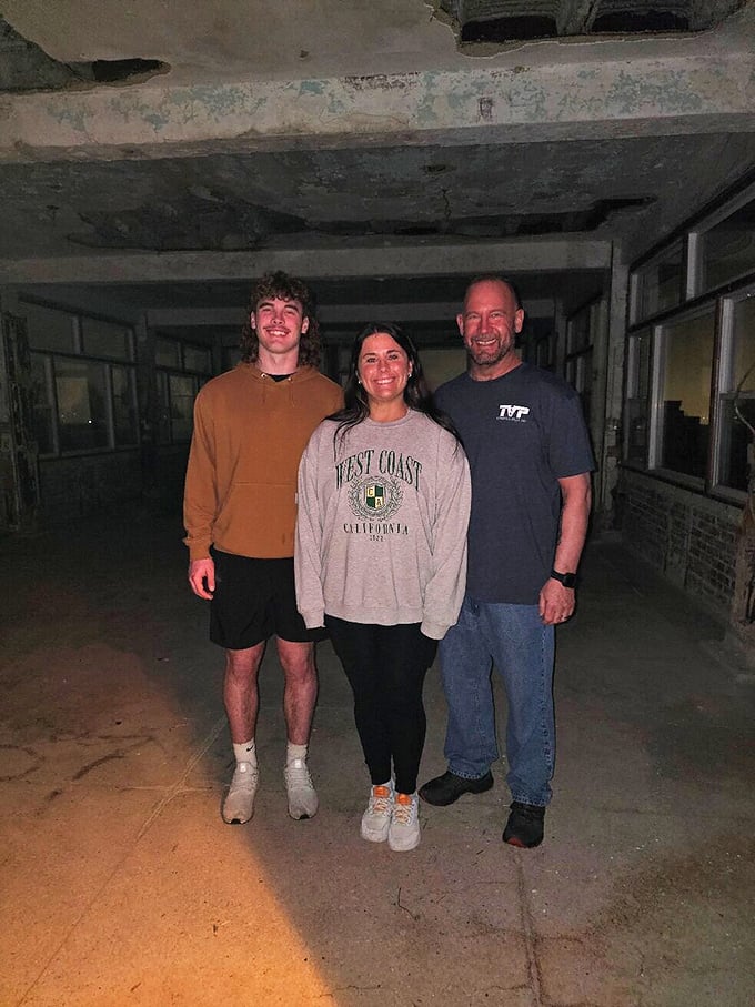 Brave visitors smile for the camera, unaware that in haunted locations, you're never really alone in the frame.