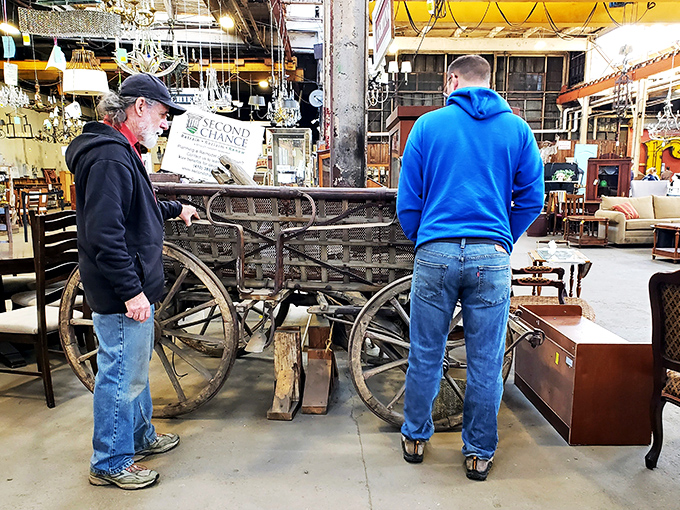 Two treasure hunters contemplating what appears to be a horse-drawn cart. One man's "what is that?" is another's "I need that!"