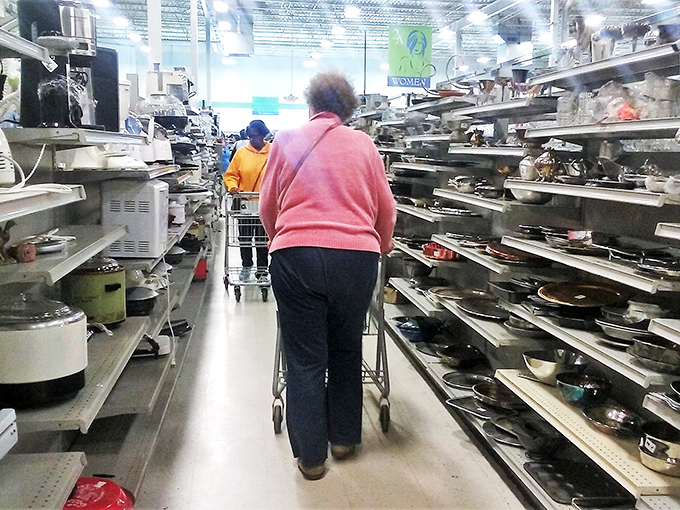 The front lines of thrift warfare. That sign promising "1000s of items put out daily" isn't kidding—the thrill of the hunt is real here.
