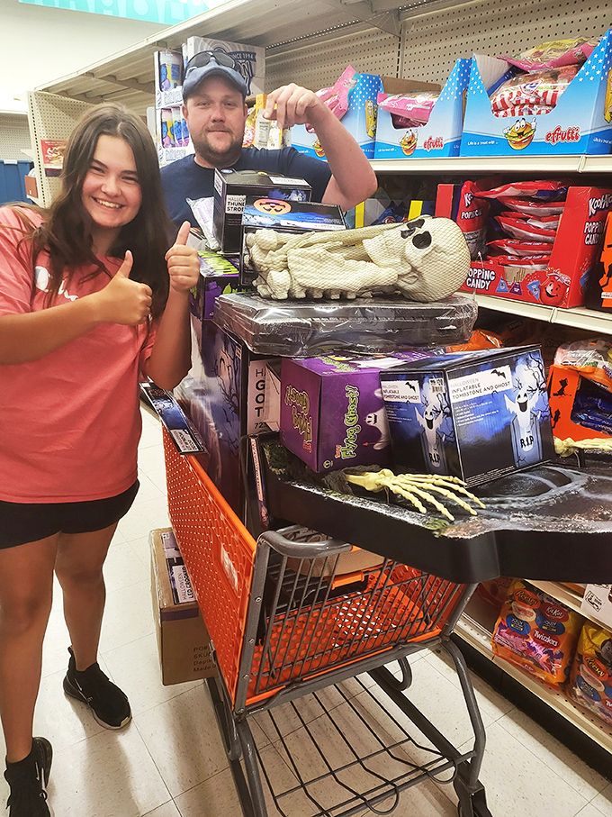 The universal victory pose of discount hunters who've bagged the Halloween decorations that will make the neighbors wonder where you shop.