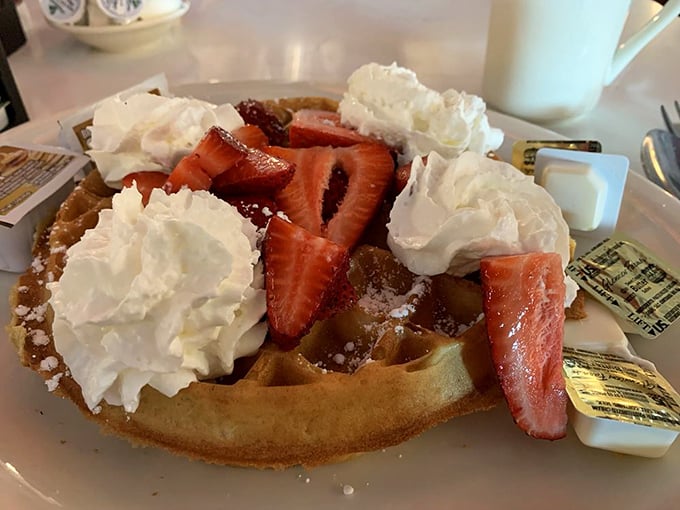Waffle architecture at its finest&mdash;golden foundation, structural integrity maintained by whipped cream buttresses, with strawberries adding both color and purpose.