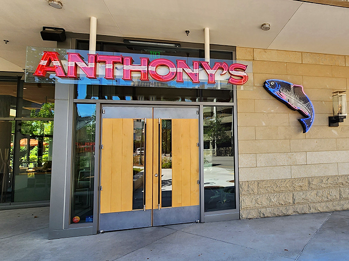 Anthony's neon-lit entrance glows like a stylish beacon for seafood lovers. Even the fish sign looks excited to be there!