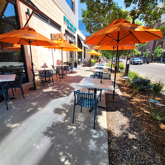 Blue Island's cheerful orange umbrellas create the perfect people-watching perch while you slurp oysters in Cherry Creek.