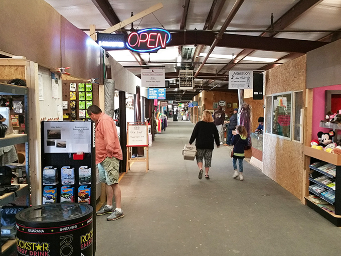 Coastal Carolina Flea Market's "OPEN" sign beckons shoppers into corridors where every booth tells a different story of commerce and collection.