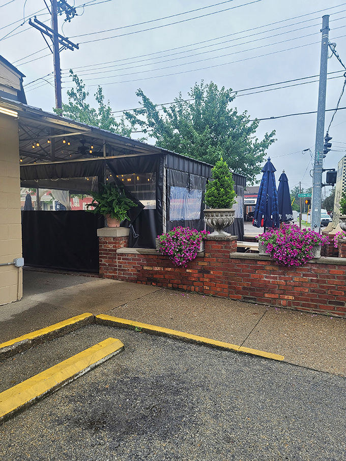 The Fishery's covered patio brings a touch of secret garden charm to your seafood feast - flowers, string lights, and fried perfection.