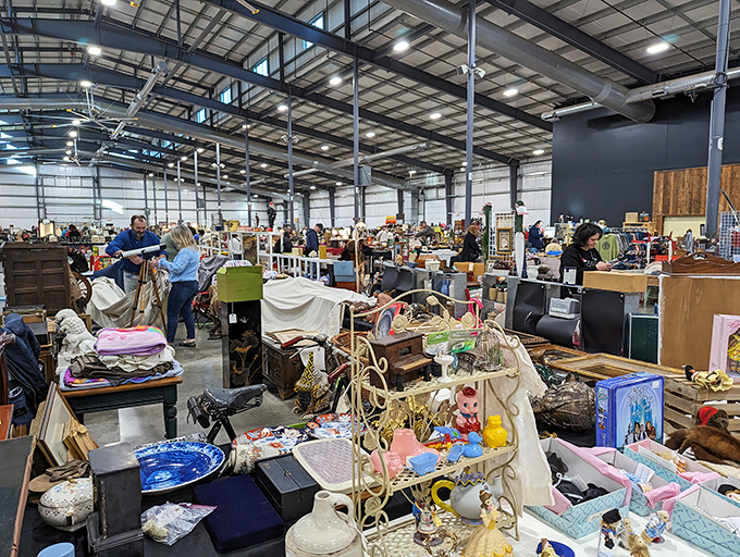 Serious collectors and casual browsers unite under exposed beams. The thrill of the find transcends generations.