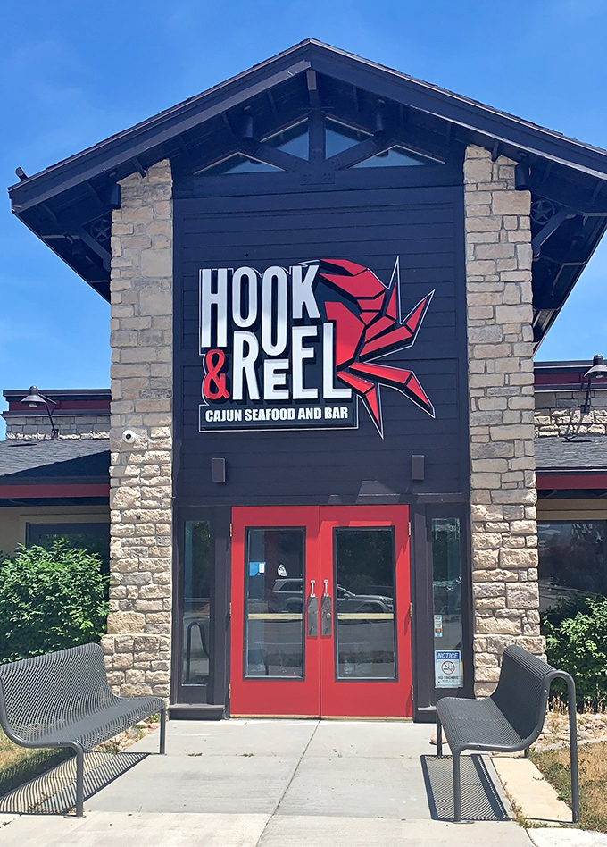 Hook & Reel's stone-and-timber entrance stands like a gateway to Cajun country, where seafood comes by the pound and bibs are non-negotiable.
