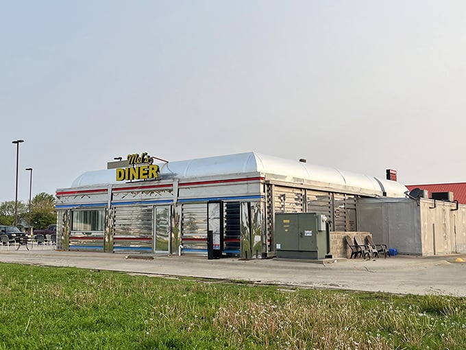 Mel's Diner glows with neon promise at night, like a chrome-plated dream serving breakfast whenever you need it.