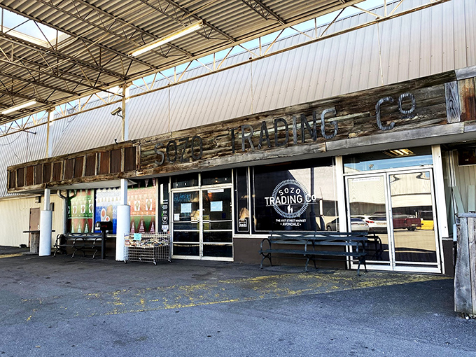 Sozo Trading Co.'s rustic wooden sign whispers of hipster finds within. Thrifting with an industrial-chic accent!