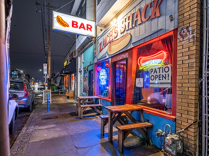 Where neon lights and picnic tables create the perfect backdrop for hot dog consumption that borders on performance art.