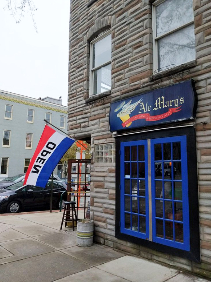 The "OPEN" flag waves like a beacon to burger pilgrims&mdash;Ale Mary's modest entrance conceals extraordinary flavors within these historic walls.