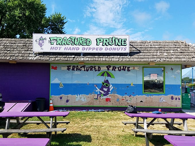 The beachside mural and purple picnic tables create the perfect backdrop for donut decisions that will haunt your dreams—in the best way.