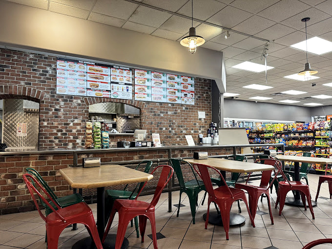 Inside Gandolfo's, those red chairs aren't just seating &ndash; they're front-row tickets to a Broadway show starring pastrami and rye.