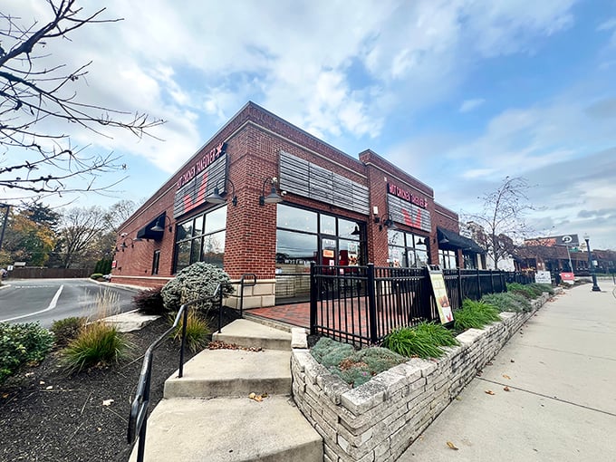 That brick facade and black fence hide a world of spicy chicken treasures &ndash; your endorphins are about to throw a party.