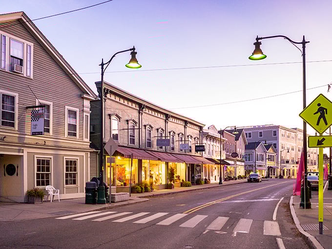 As evening falls on Mystic's historic street, the glow from shop windows promises discoveries around every corner